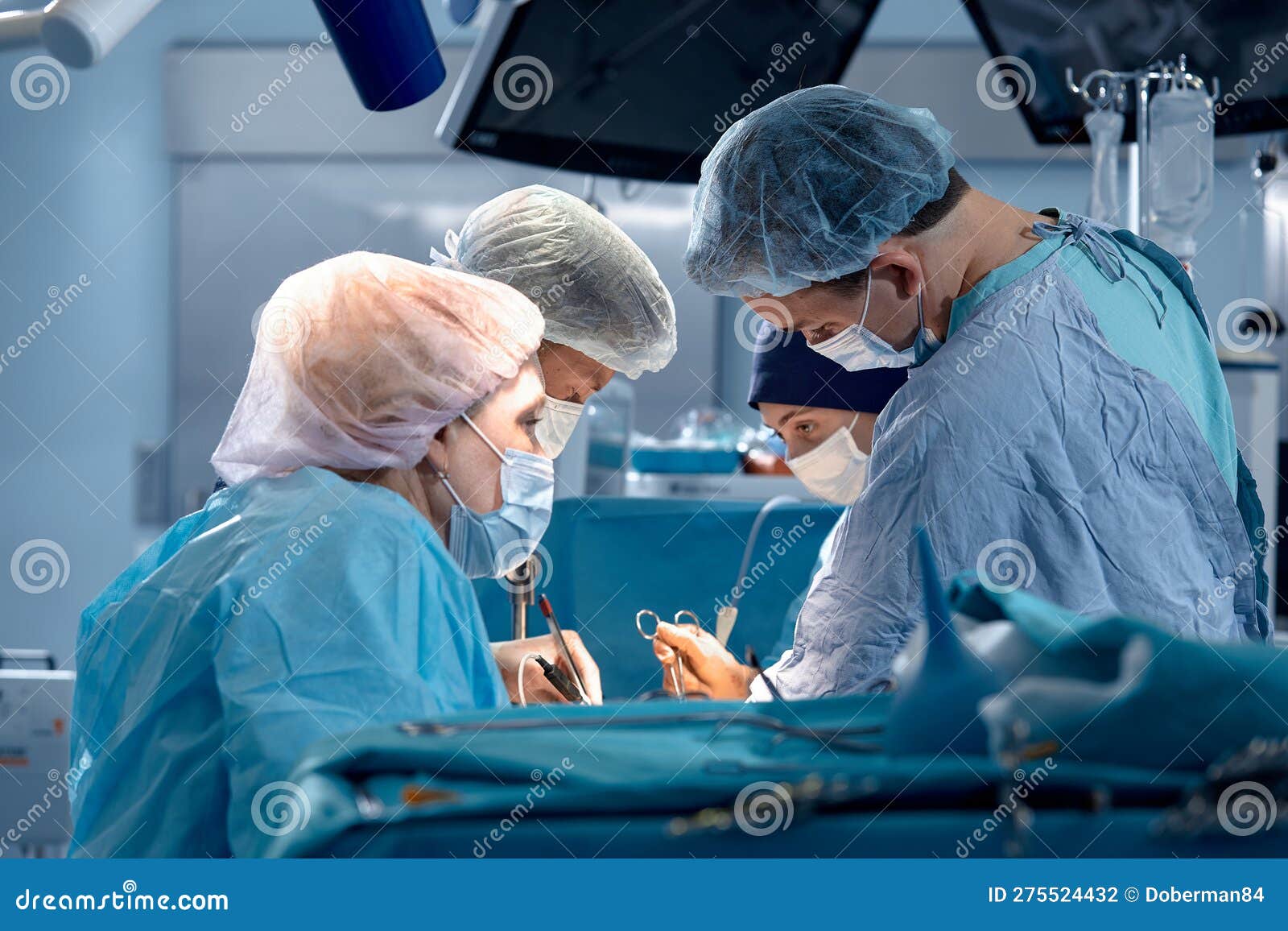 Faces of Surgeons in the Operating Room during the Operation. Modern ...