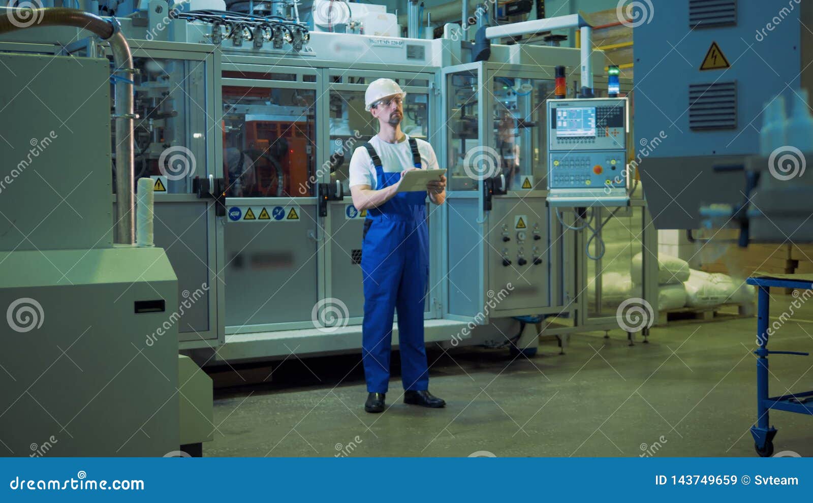 Factory Employee is Observing Production Process in a Factory Stock ...