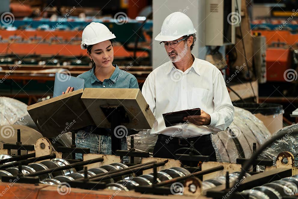 Factory Engineer with Assistant Using Laptop Inspect Factory ...