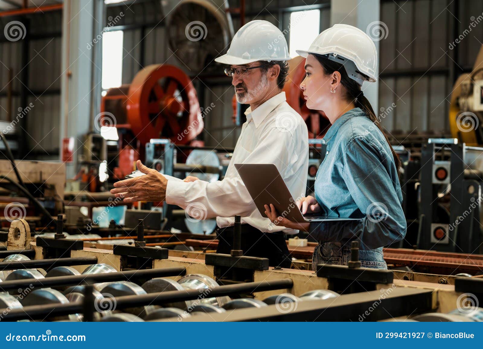 Factory Engineer with Assistant Using Laptop Inspect Factory ...