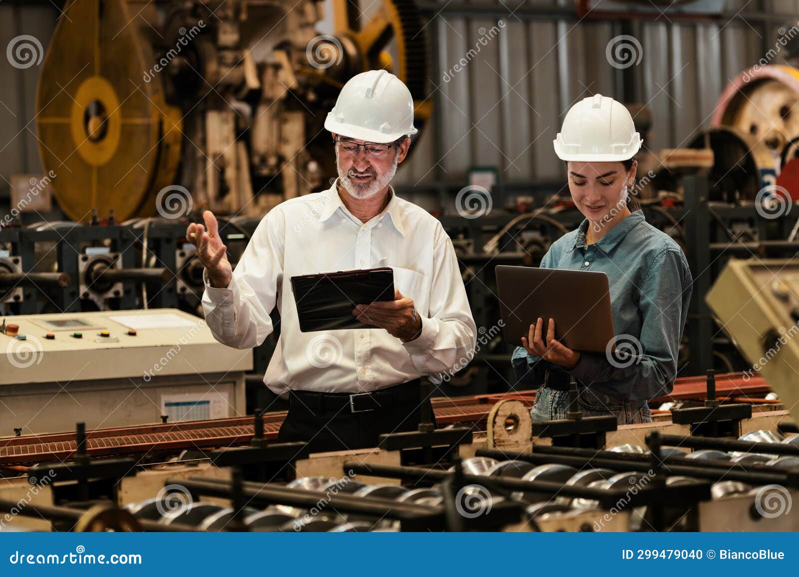 Factory Engineer with Assistant Using Laptop Inspect Factory ...