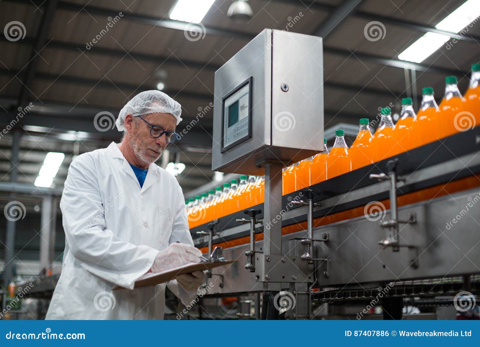 Factory Engineer Maintaining Record on Clipboard in Factory Stock Photo ...