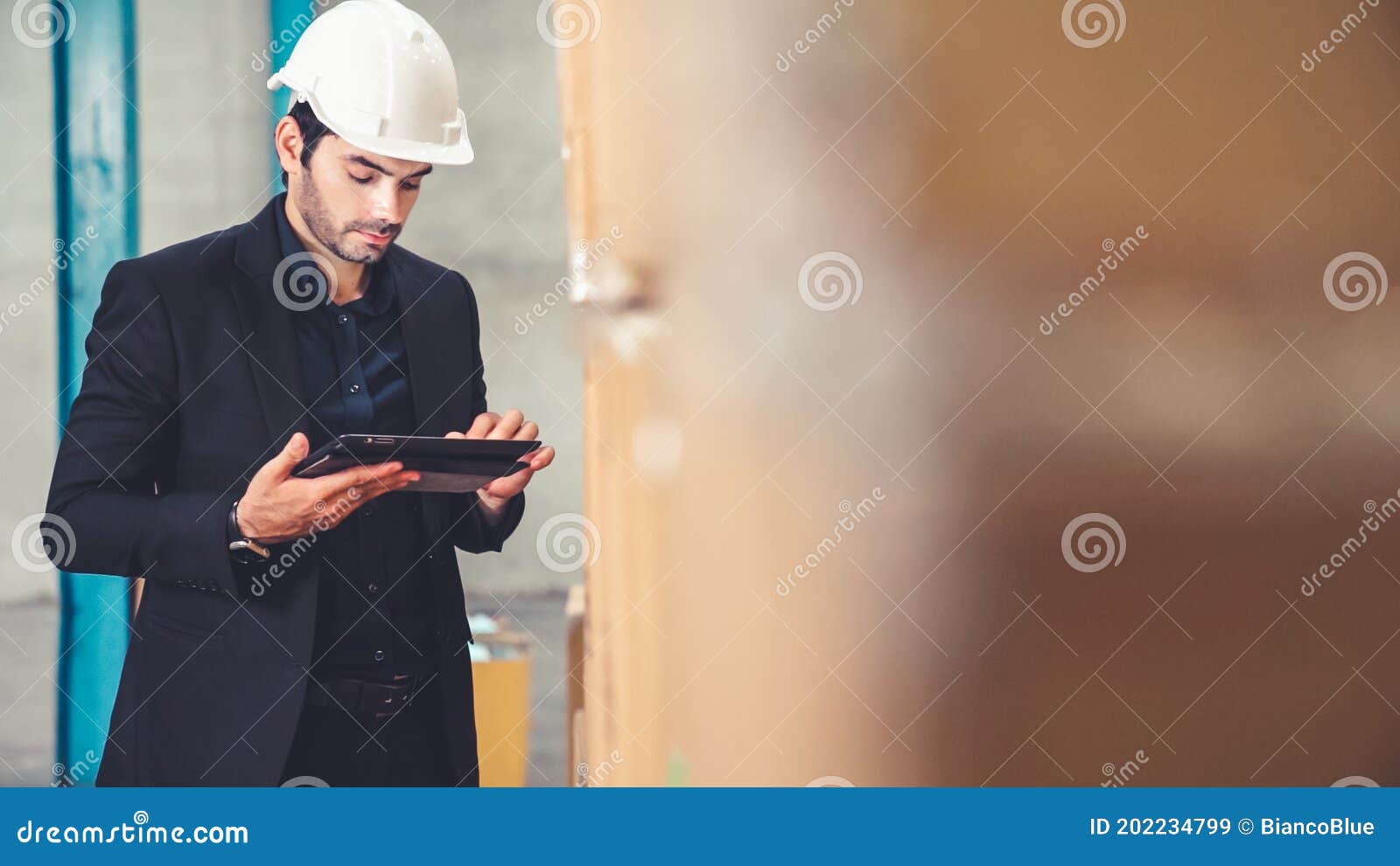 Factory Manager Using Tablet Computer in Warehouse or Factory Stock ...