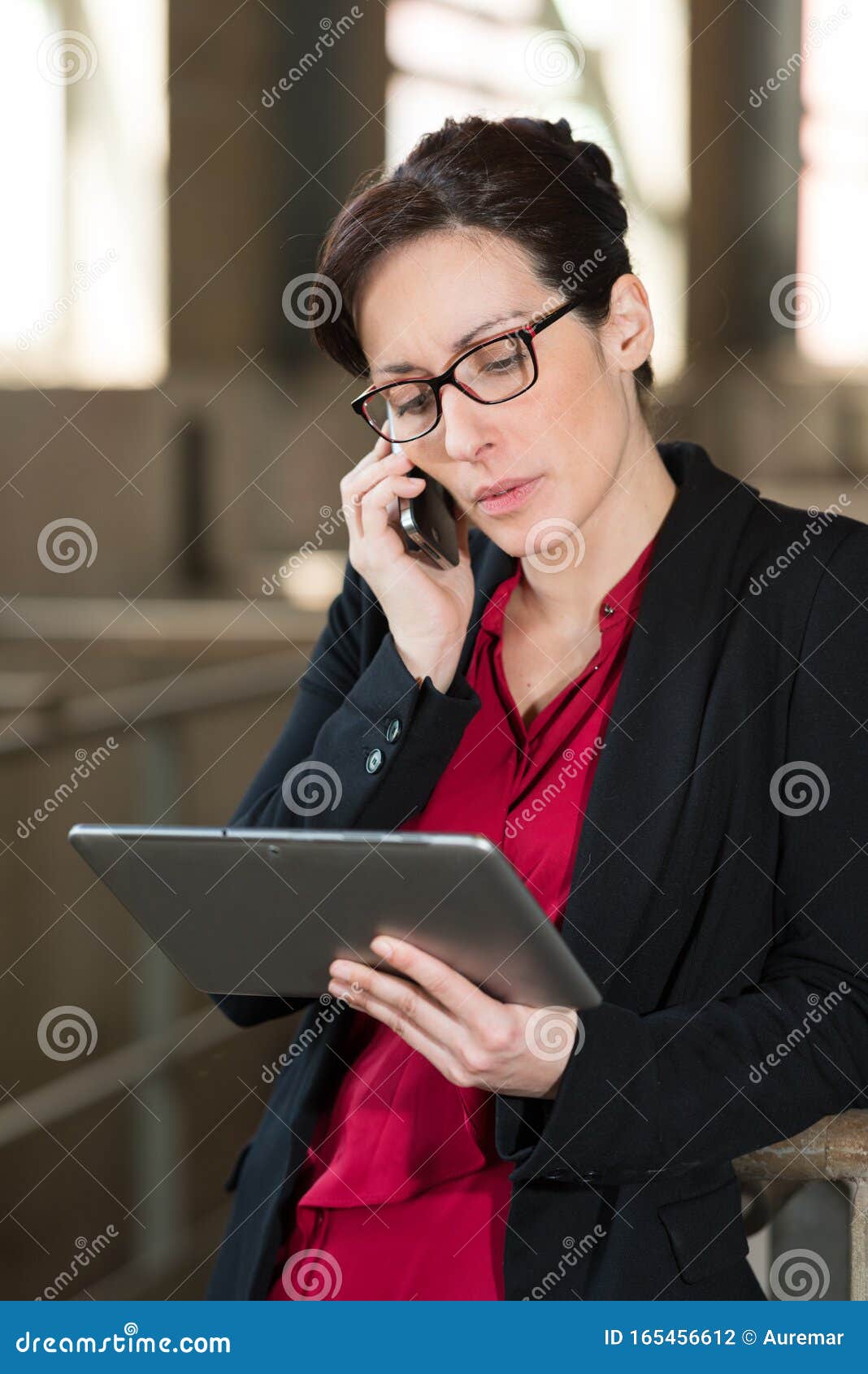 Factory Marketing Supervisor Looking at Information on Tablet Stock ...