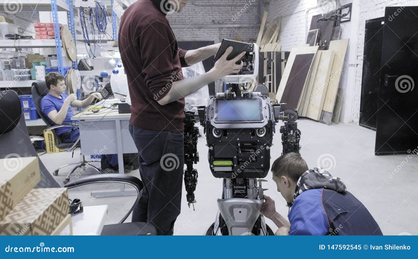 Factory for the Production of Robots. Two Engineers are Examining a ...