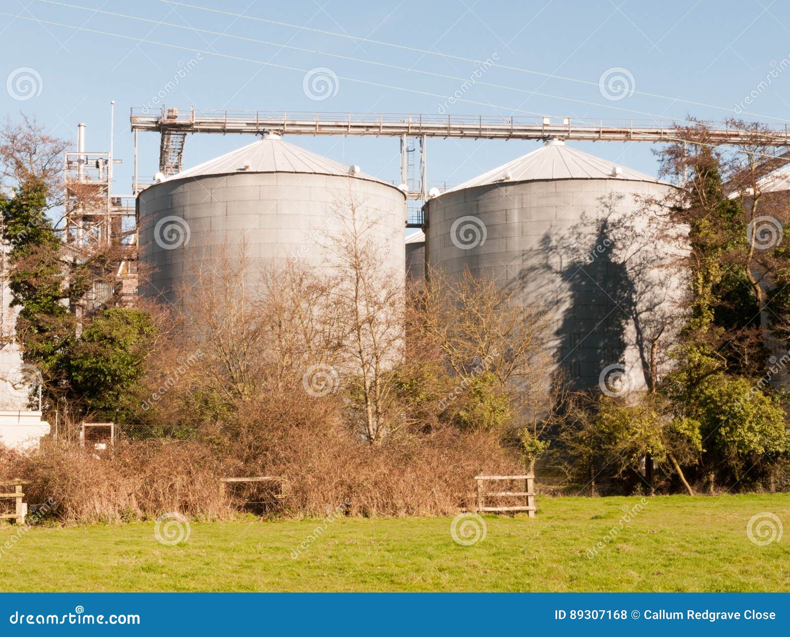 Factory Towers Seen from a Field in Spring Stock Photo - Image of ...