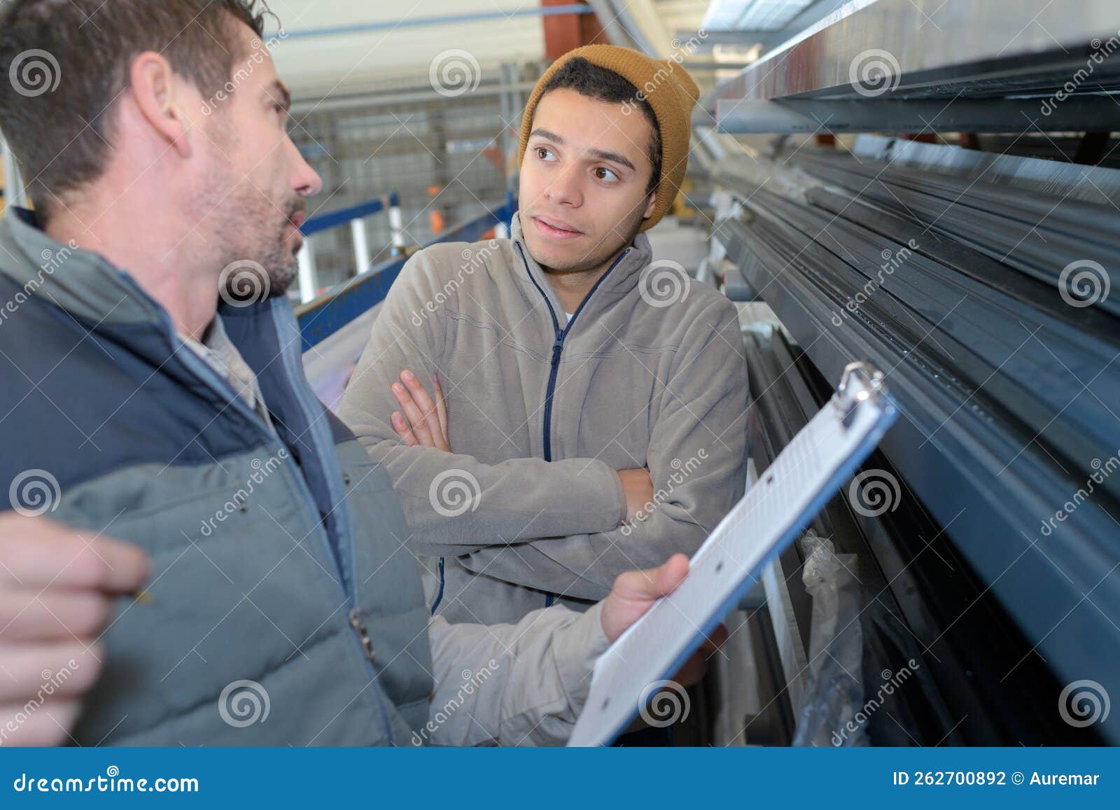 Factory Worker Discussing Data with Supervisor in Metal Factory Stock ...