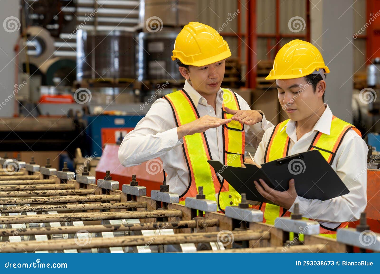 Factory Worker Operating Metal Stamping Machine with Engineer ...