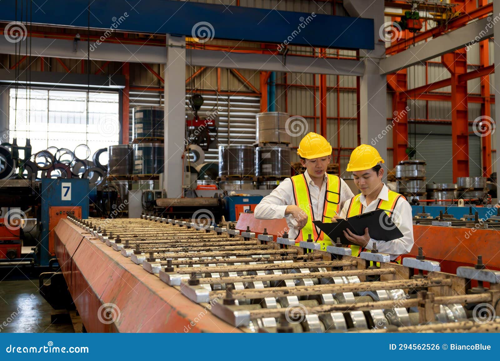 Factory Worker Operating Metal Stamping Machine with Engineer ...