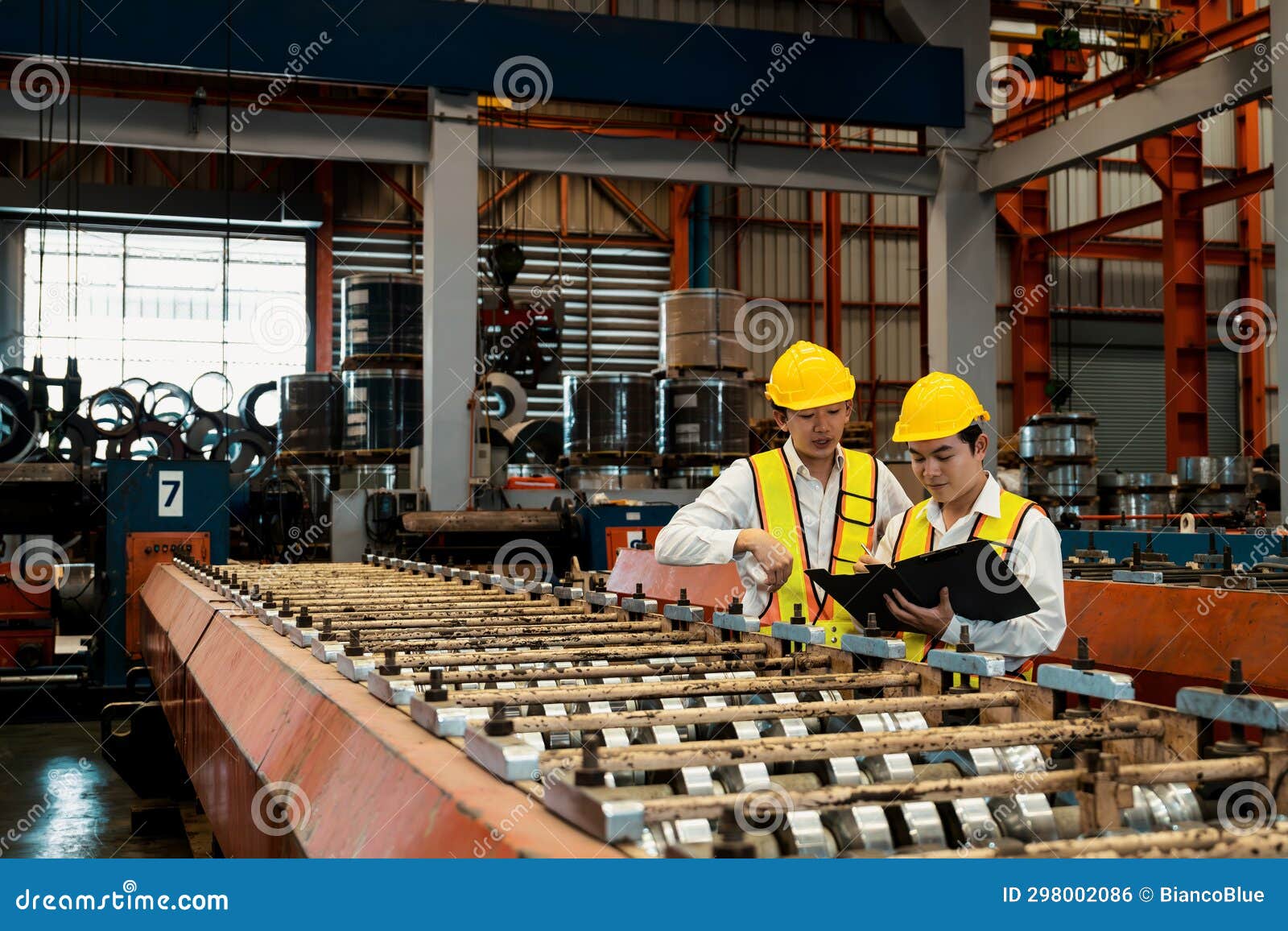 Factory Worker Operating Metal Stamping Machine with Engineer ...
