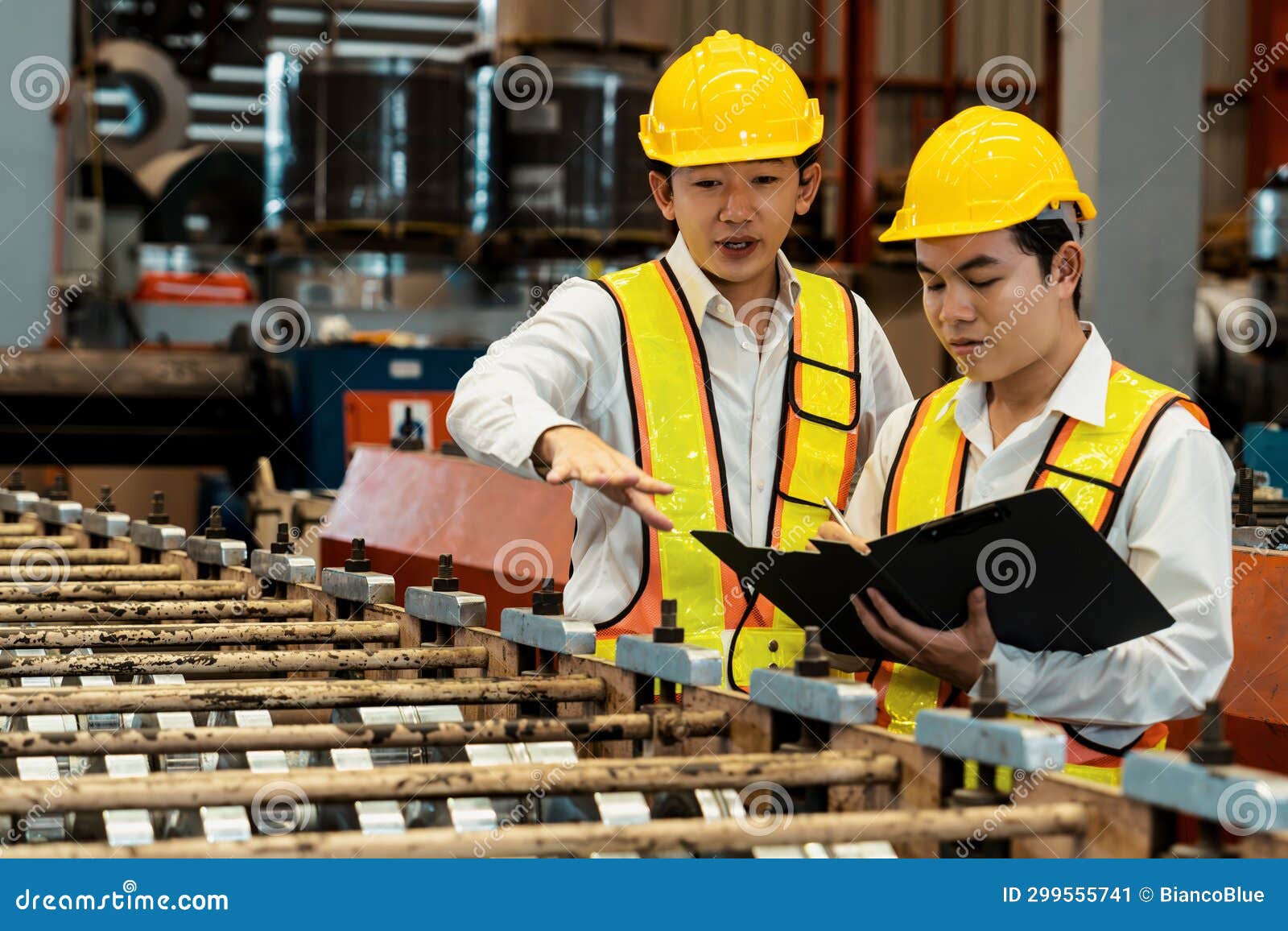 Factory Worker Operating Metal Stamping Machine with Engineer ...