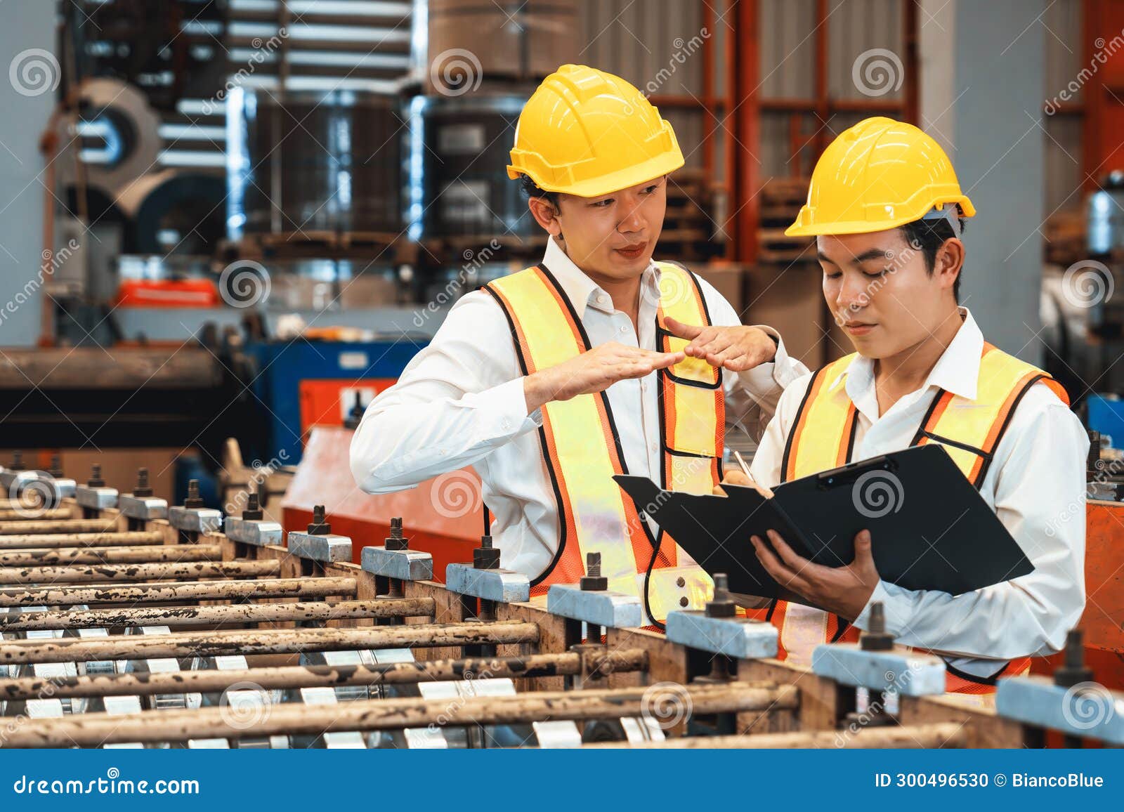 Factory Worker Operating Metal Stamping Machine with Engineer ...