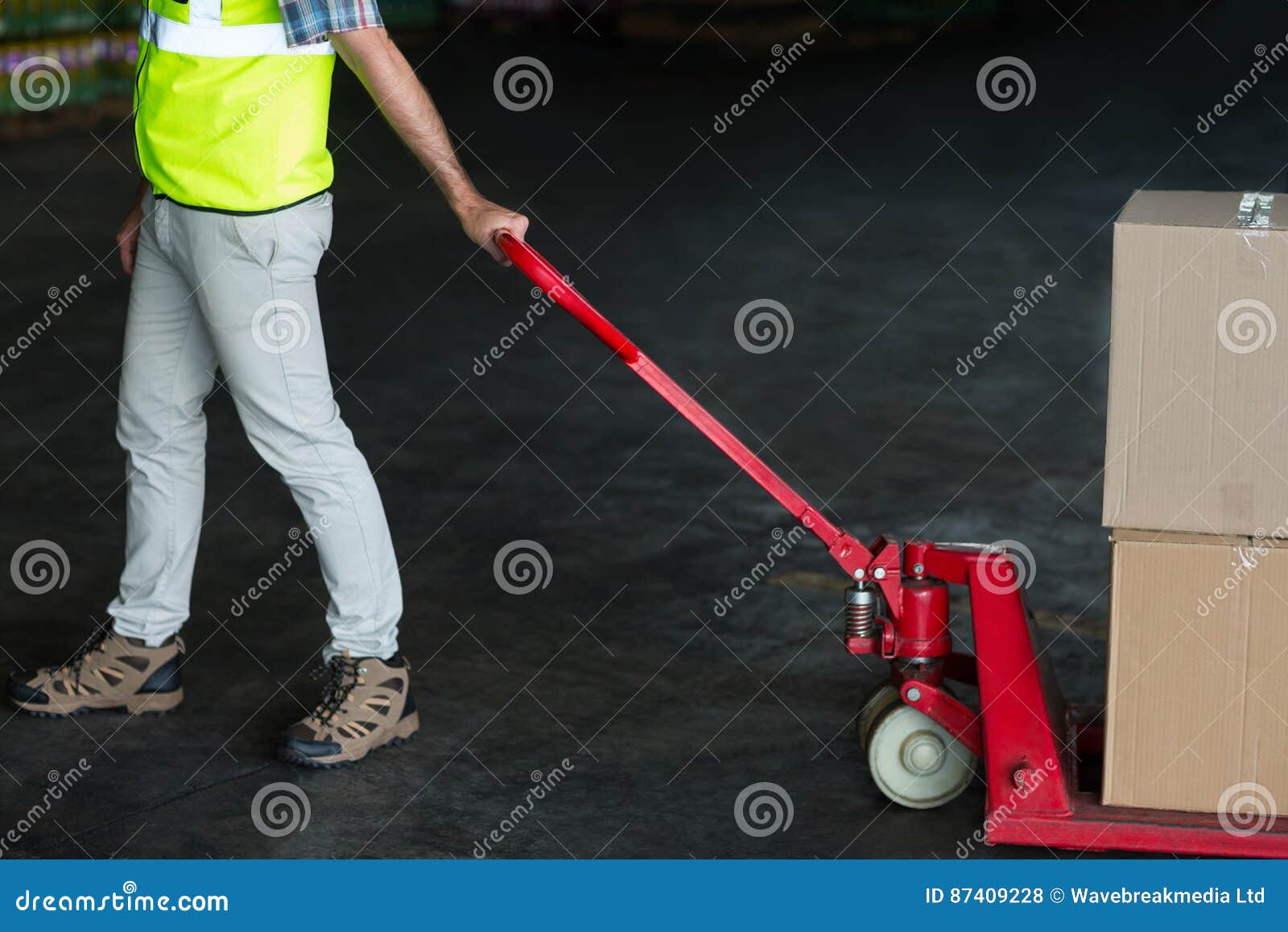 Factory Worker Pulling Trolley of Cardboard Boxes Stock Photo - Image ...