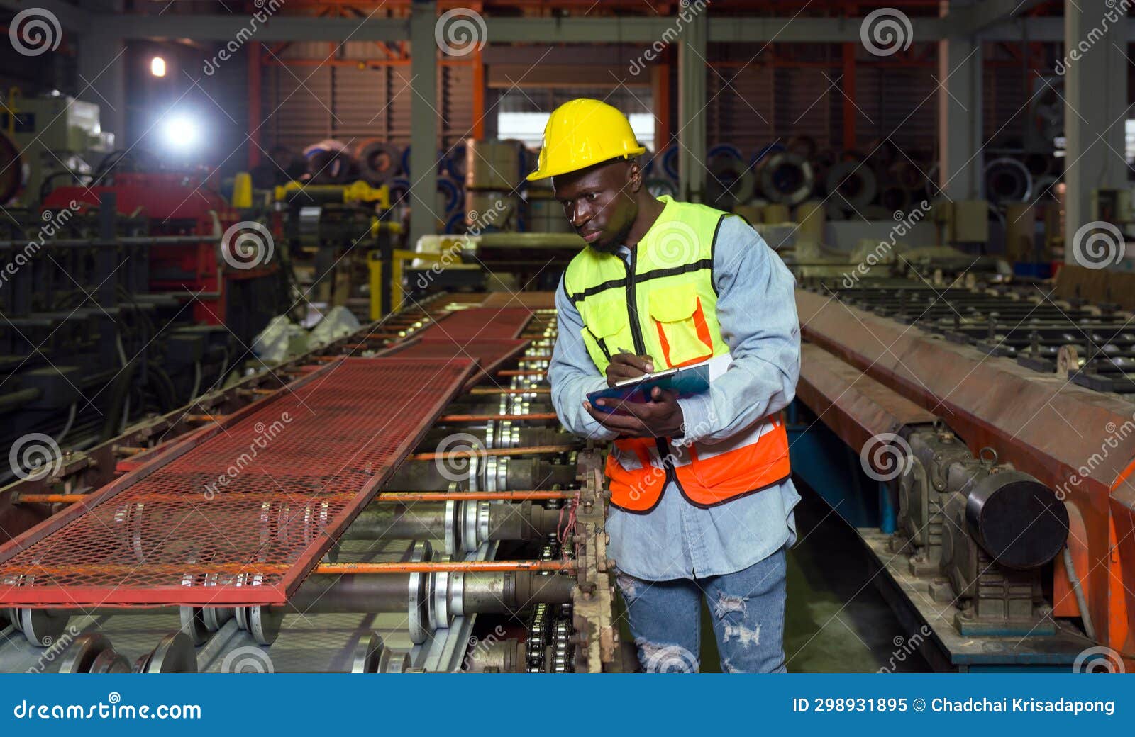 A Factory Worker is Standing on a Production Line Conveyor Belt ...