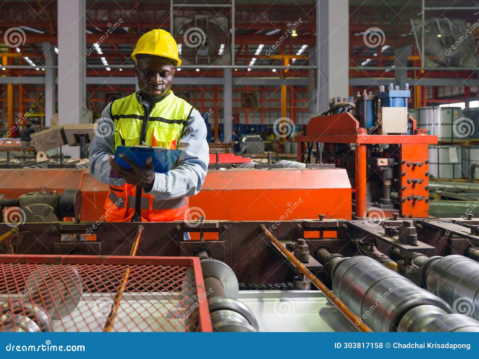 A Factory Worker is Standing on a Production Line Conveyor Belt ...