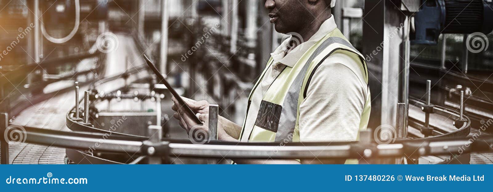 Factory Worker Using a Digital Tablet Near the Production Line Stock ...