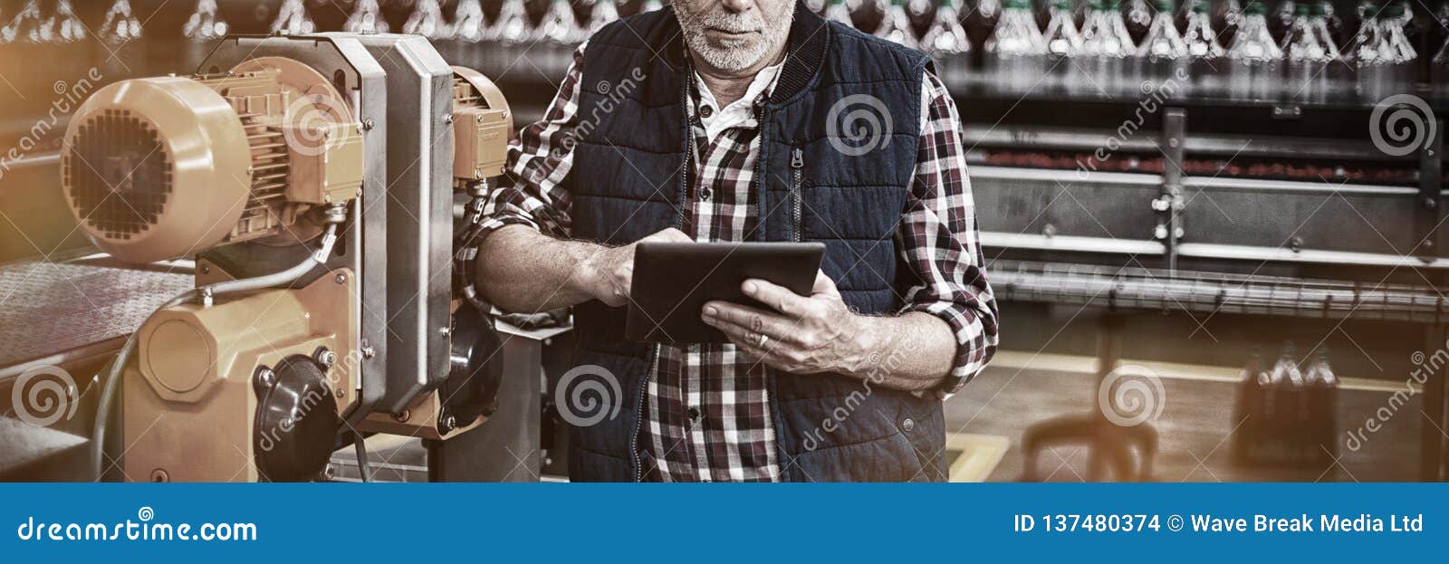 Factory Worker Using Digital Tablet Next To Production Line Stock Photo ...