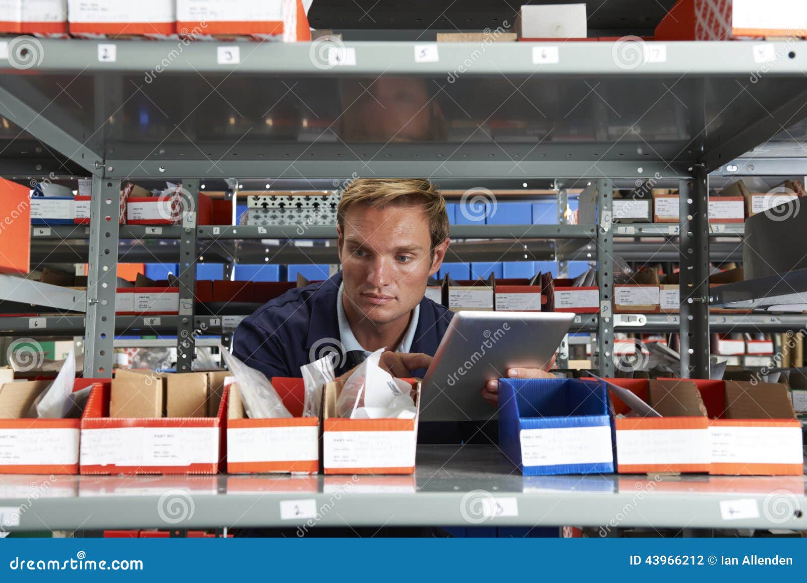 Factory Worker Using Digital Tablet in Store Room Stock Photo - Image ...