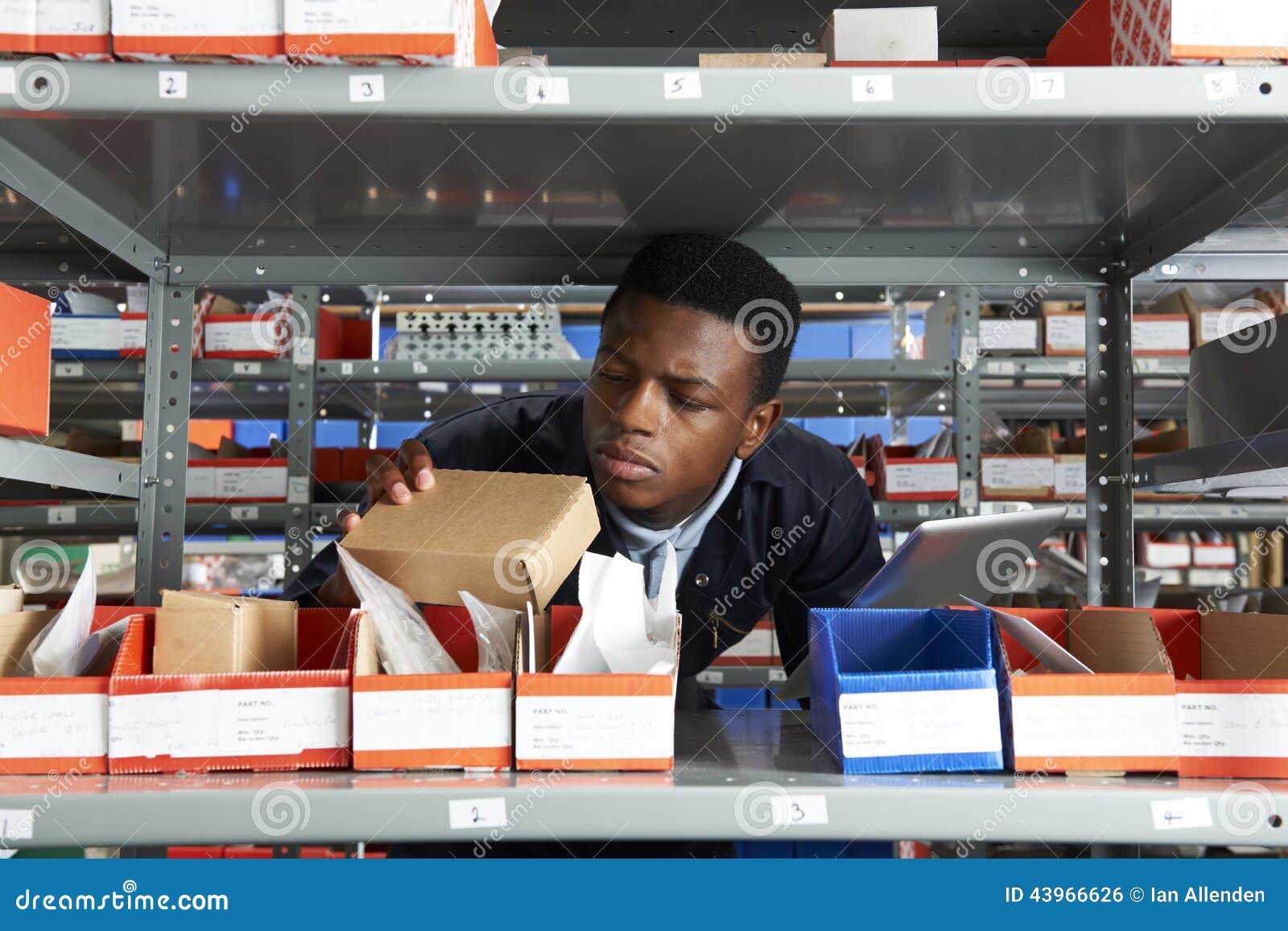 Factory Worker Using Digital Tablet in Store Room Stock Photo - Image ...