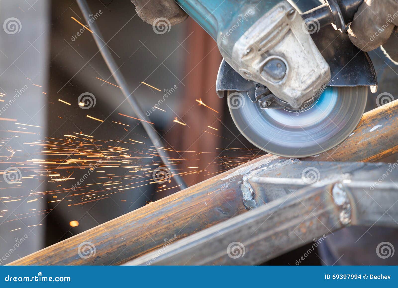 Factory Worker Using Electric Grinder Machine Cutting Metal. Sparkles ...