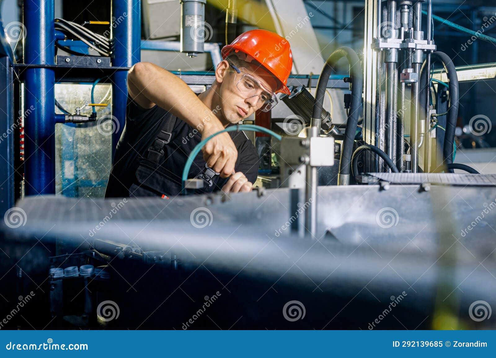 Factory Worker Working in Industrial Building Indoor. Man Fixing ...