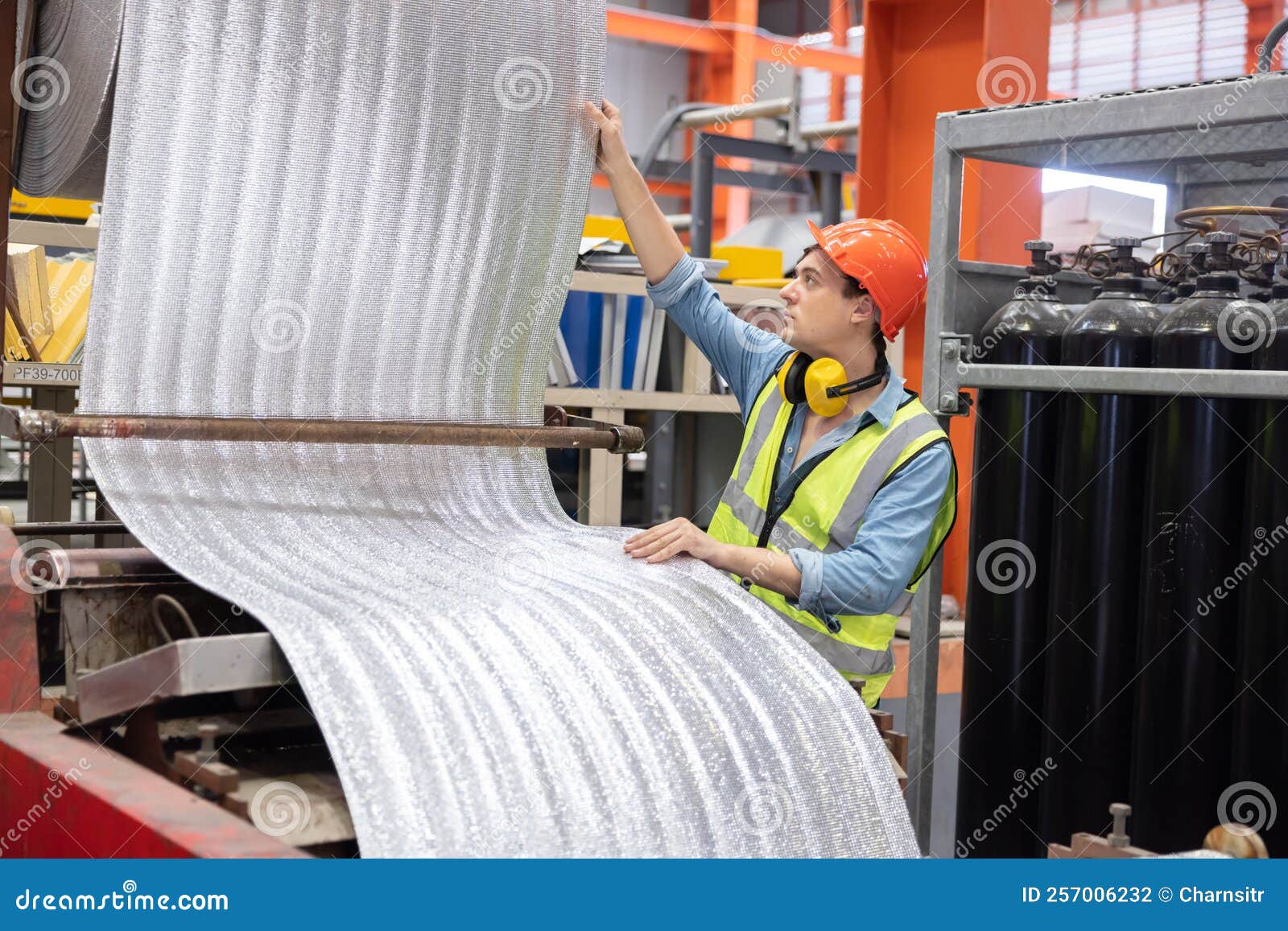 Factory Worker Working with Thermal Insulating Sheet in the Factory ...
