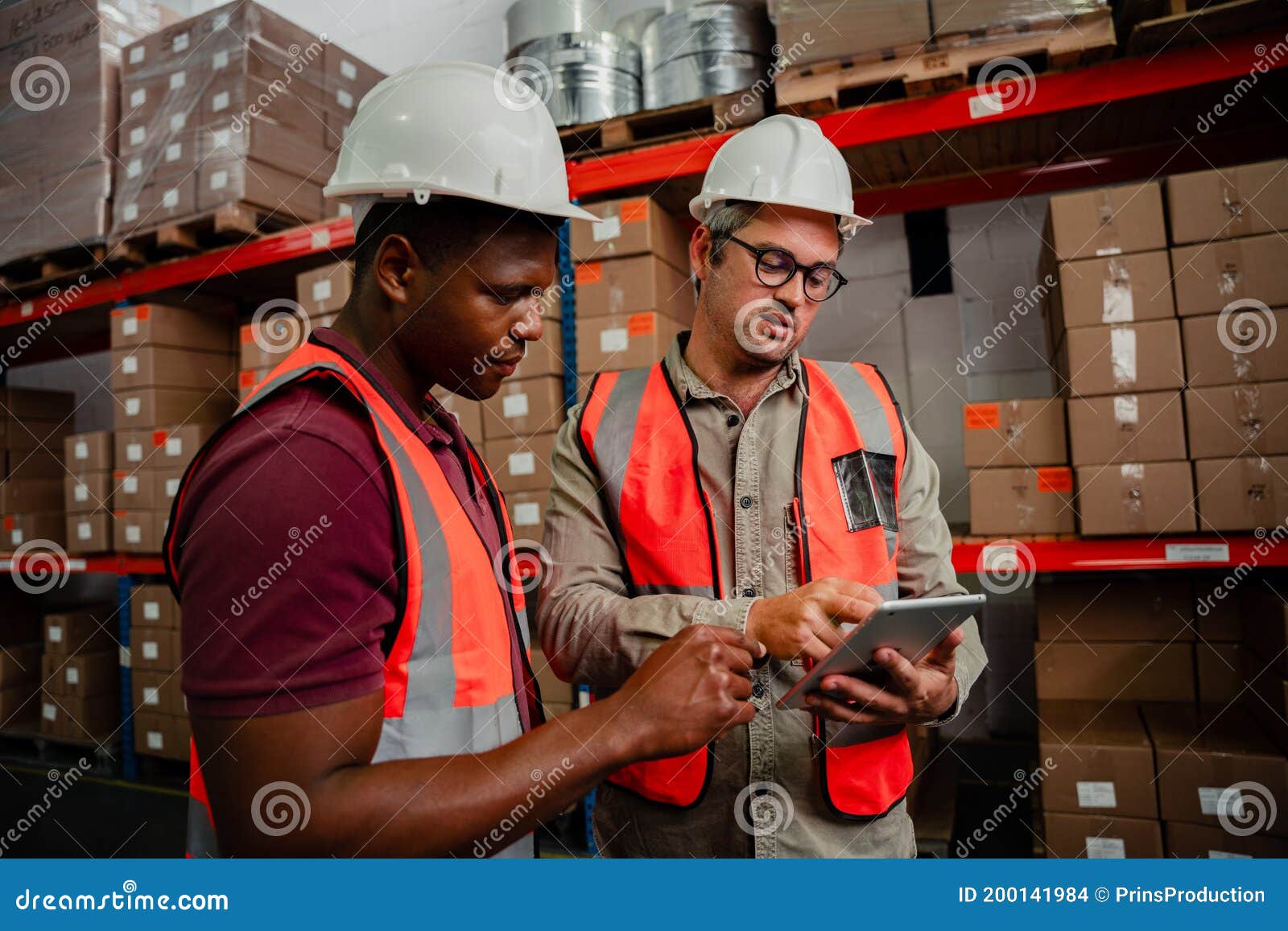 Factory Workers Browsing through Delivery Tracking on Digital Tablet ...