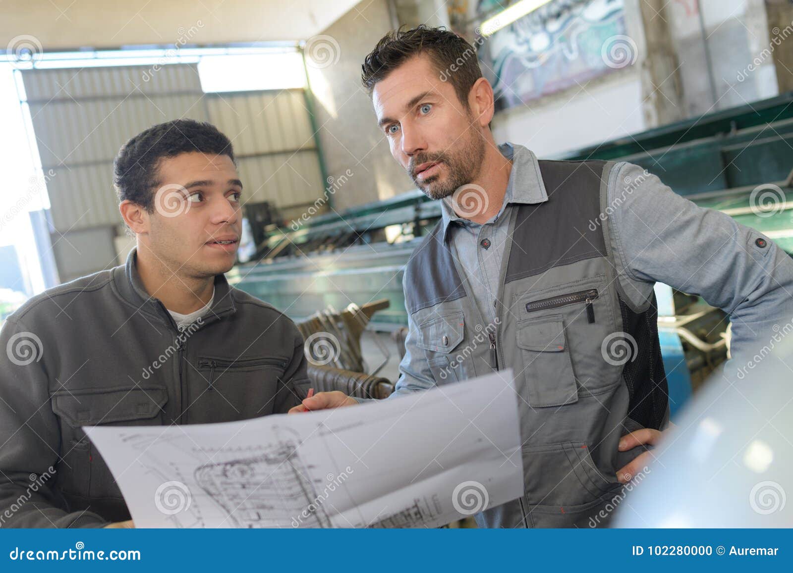 Factory Workers Checking Paper Stock Photo - Image of standing ...