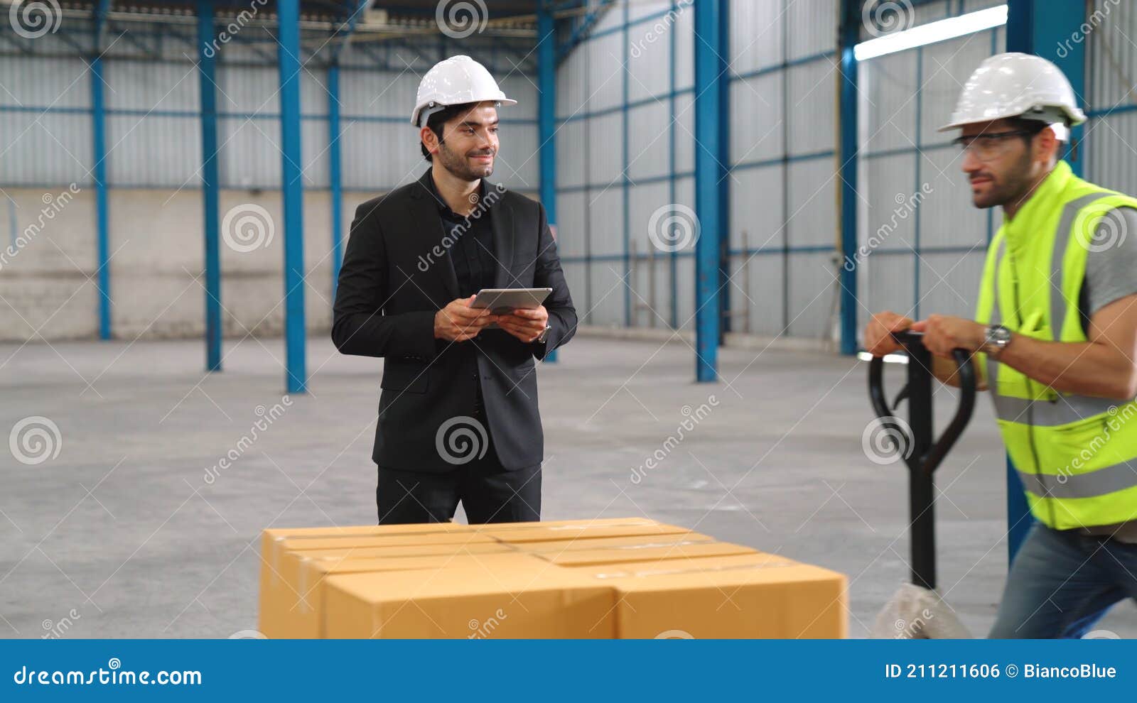 Factory Workers Deliver Boxes Package on a Pushing Trolley in the ...