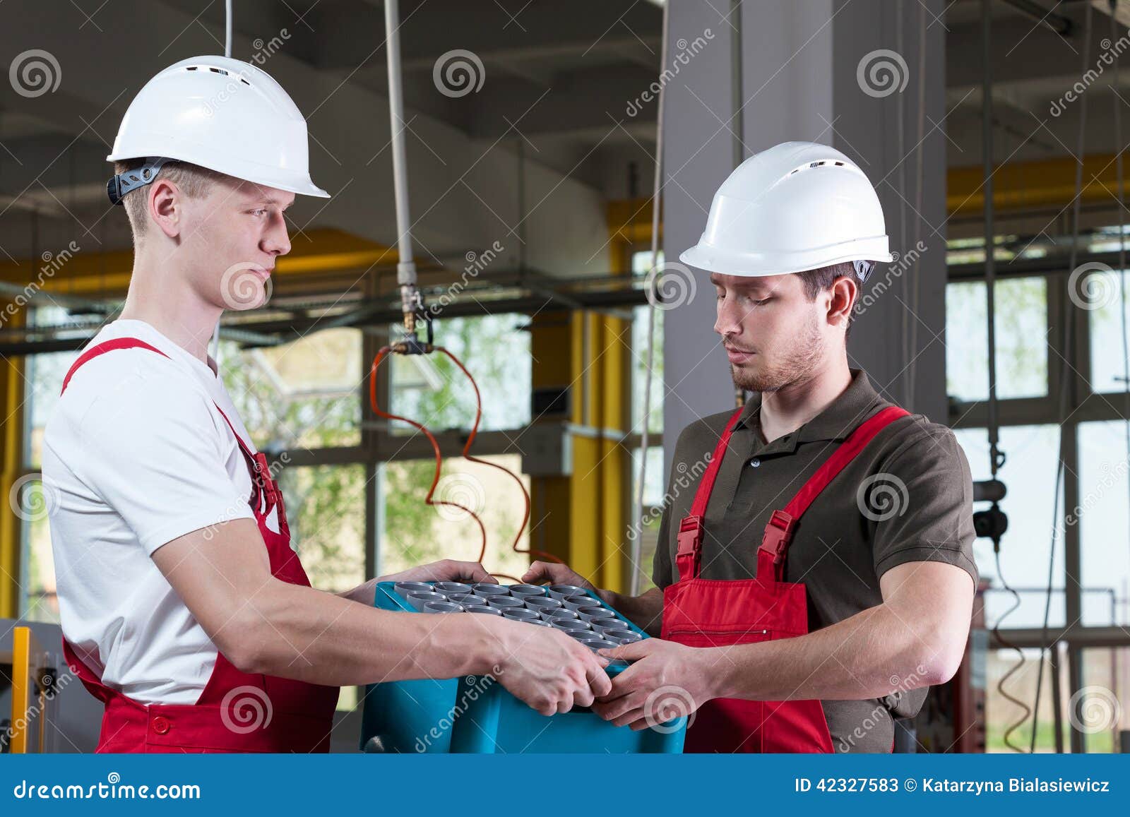 Factory Workers Lifting a Box with Hydraulic Pipes Stock Image - Image ...