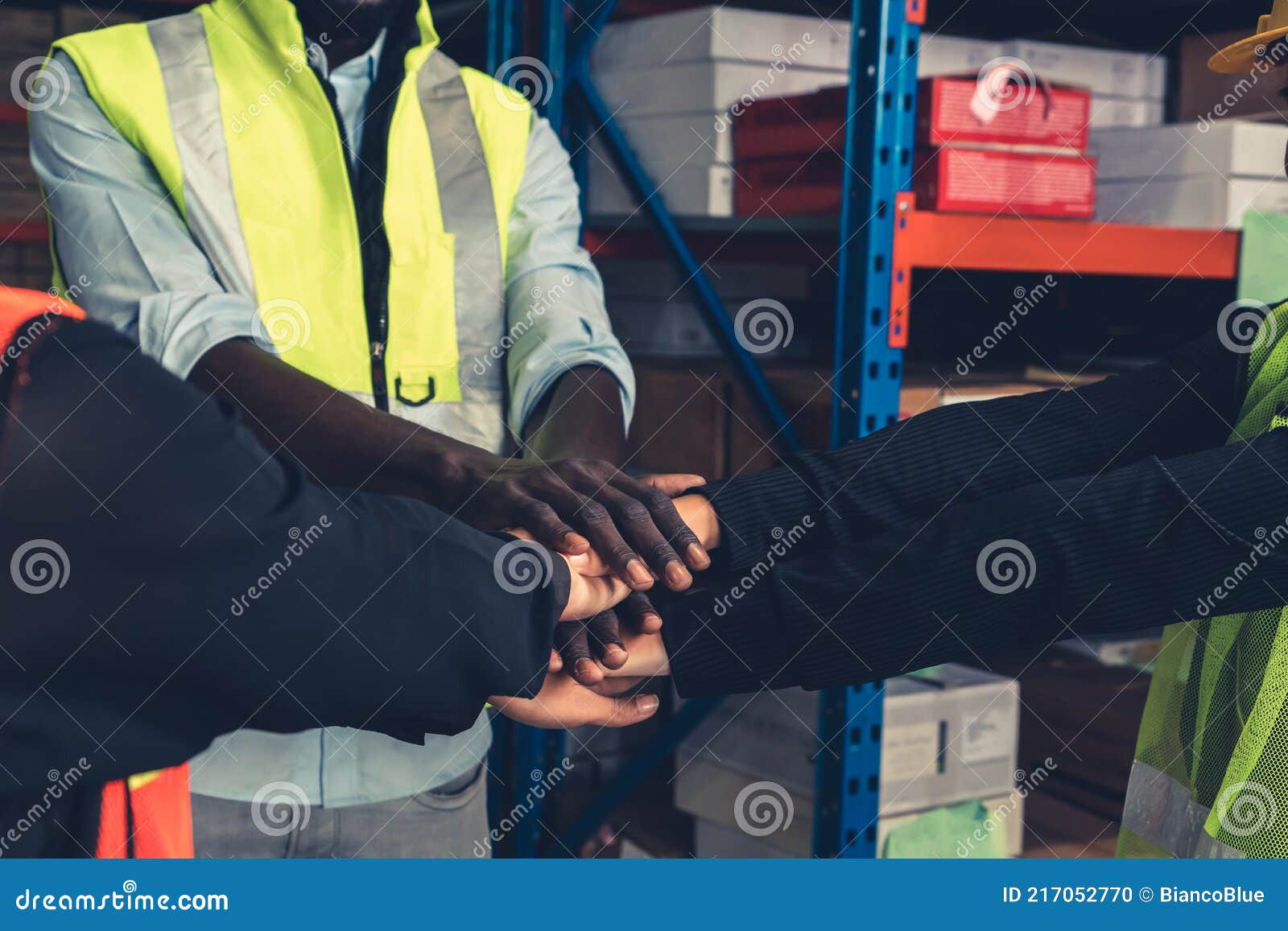 Factory Workers Stacking Hands Together in Warehouse or Storehouse ...