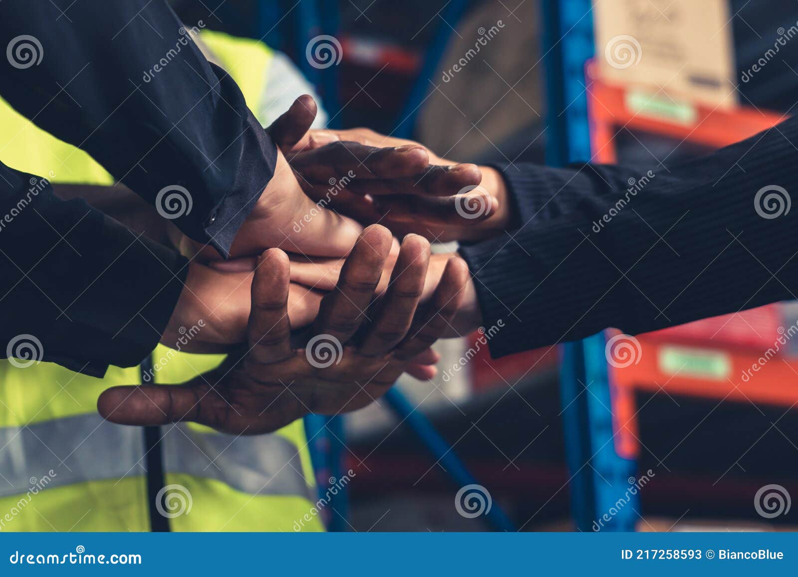 Factory Workers Stacking Hands Together in Warehouse or Storehouse ... Factory Workers Stacking Hands Together in Warehouse or Storehouse ...