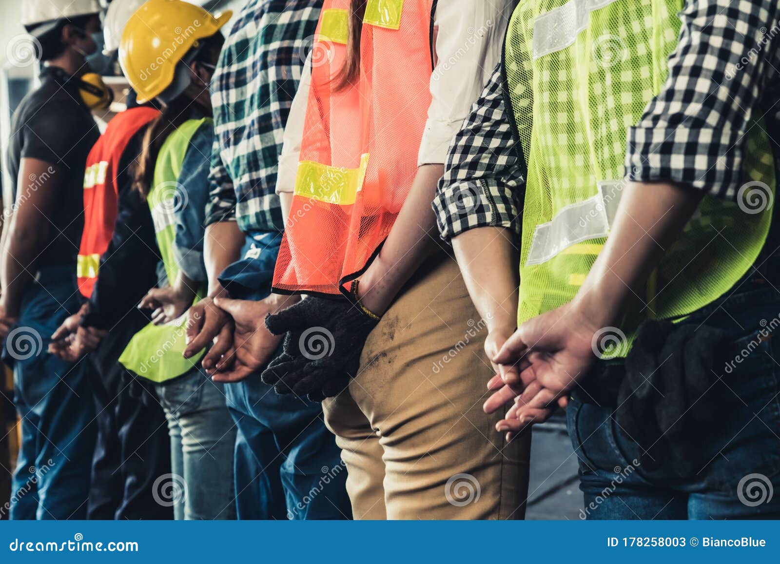 Factory Workers Standing in a Row Showing Teamwork and Unity Stock ...