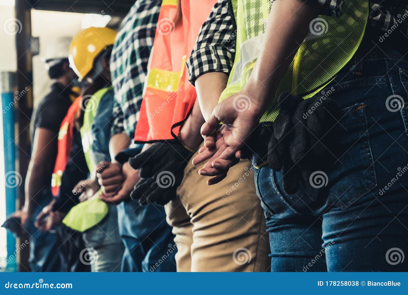 Factory Workers Standing in a Row Showing Teamwork and Unity Stock ...