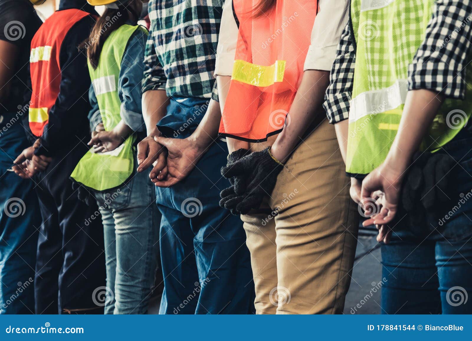 Factory Workers Standing in a Row Showing Teamwork and Unity Stock ...