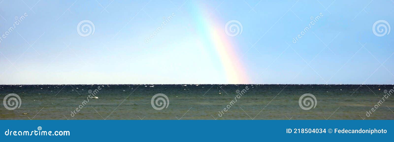 Faint Rainbow With Andean Forest Silhouette And Blue Sky At Background ...