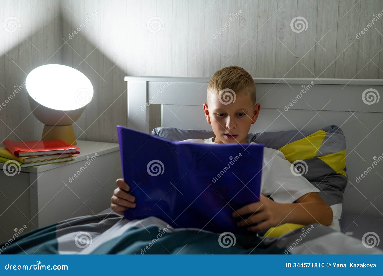 Fair-haired Teenage Boy Reading Book before Bed Stock Photo - Image of ...