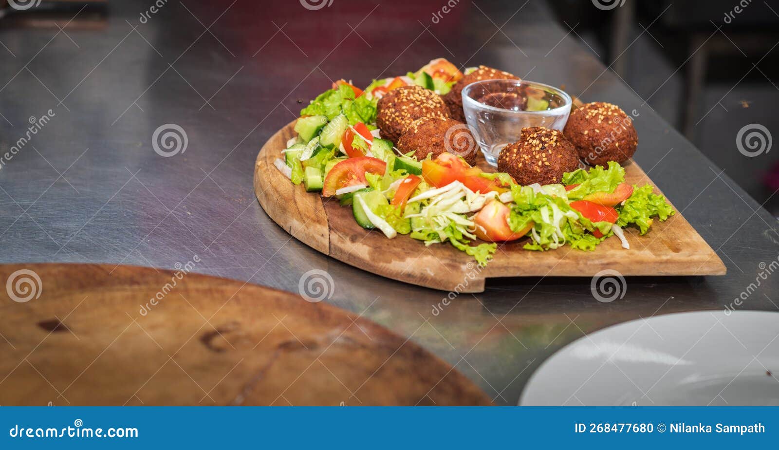 Falafel Plate with Vegetables Salad and Sauce on the Kitchen Table ...