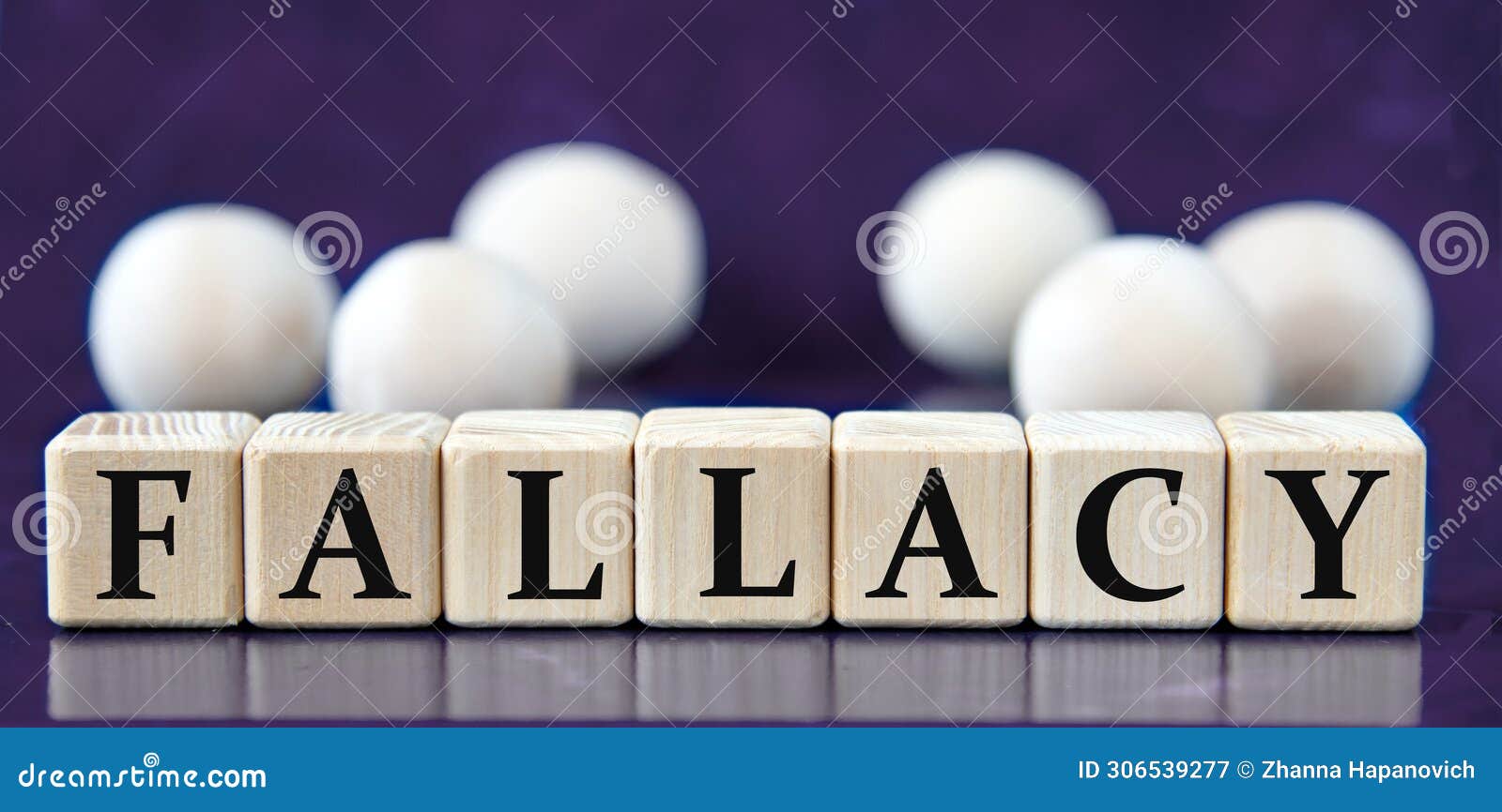 FALLACY - Word on Wooden Cubes on a Blue Background with Wooden Balls ...