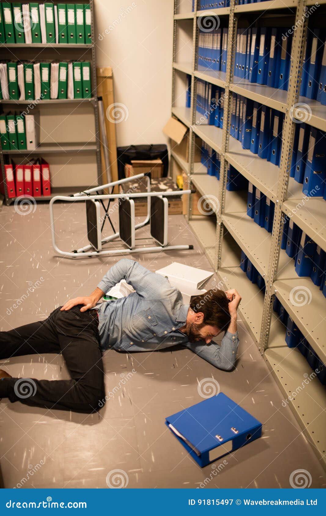 Fallen Businessman with File in Storage Room Stock Image - Image of ...