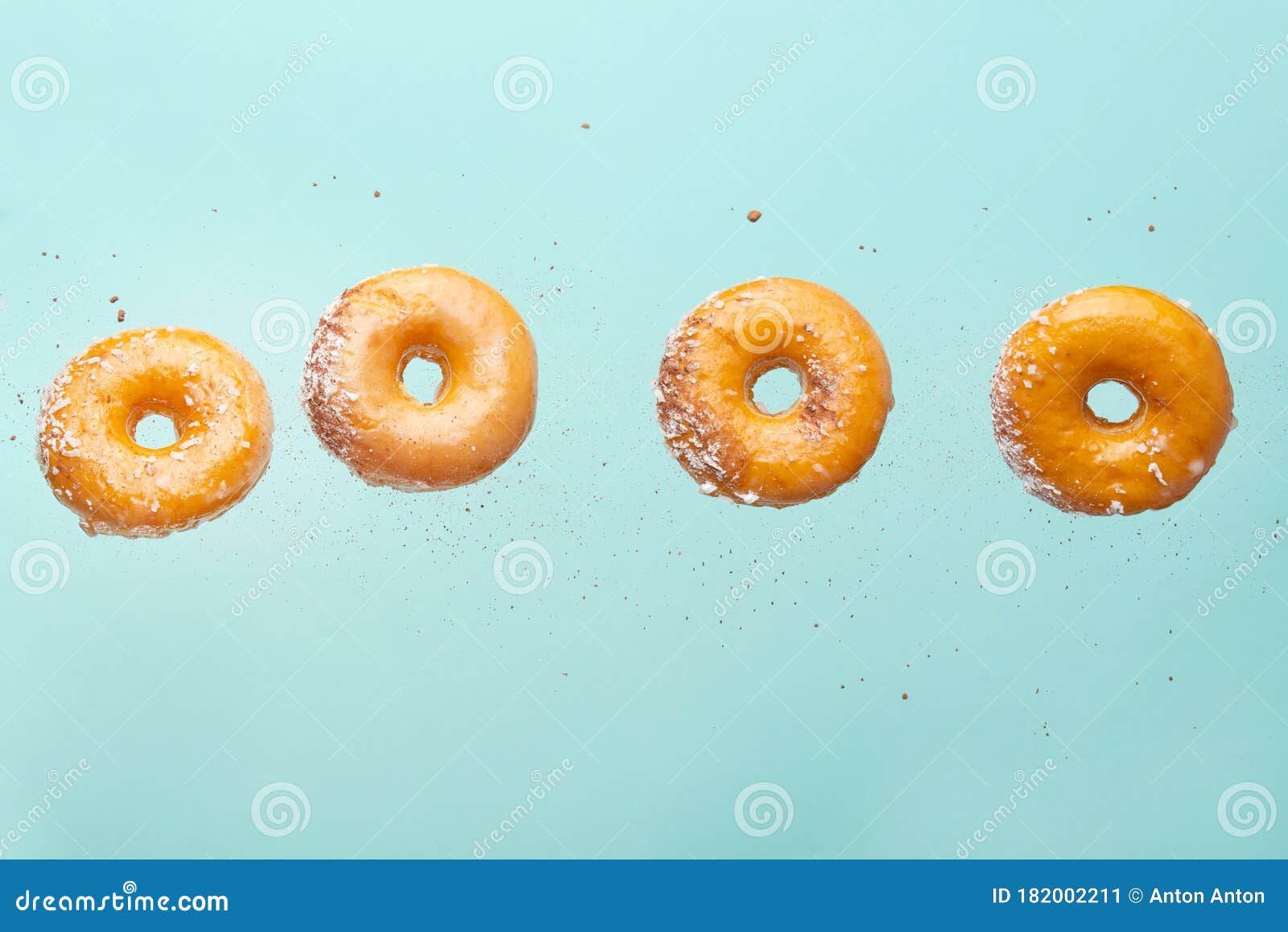 Falling Donuts with Chocolate on a Light Blue Background. Freezing in ...