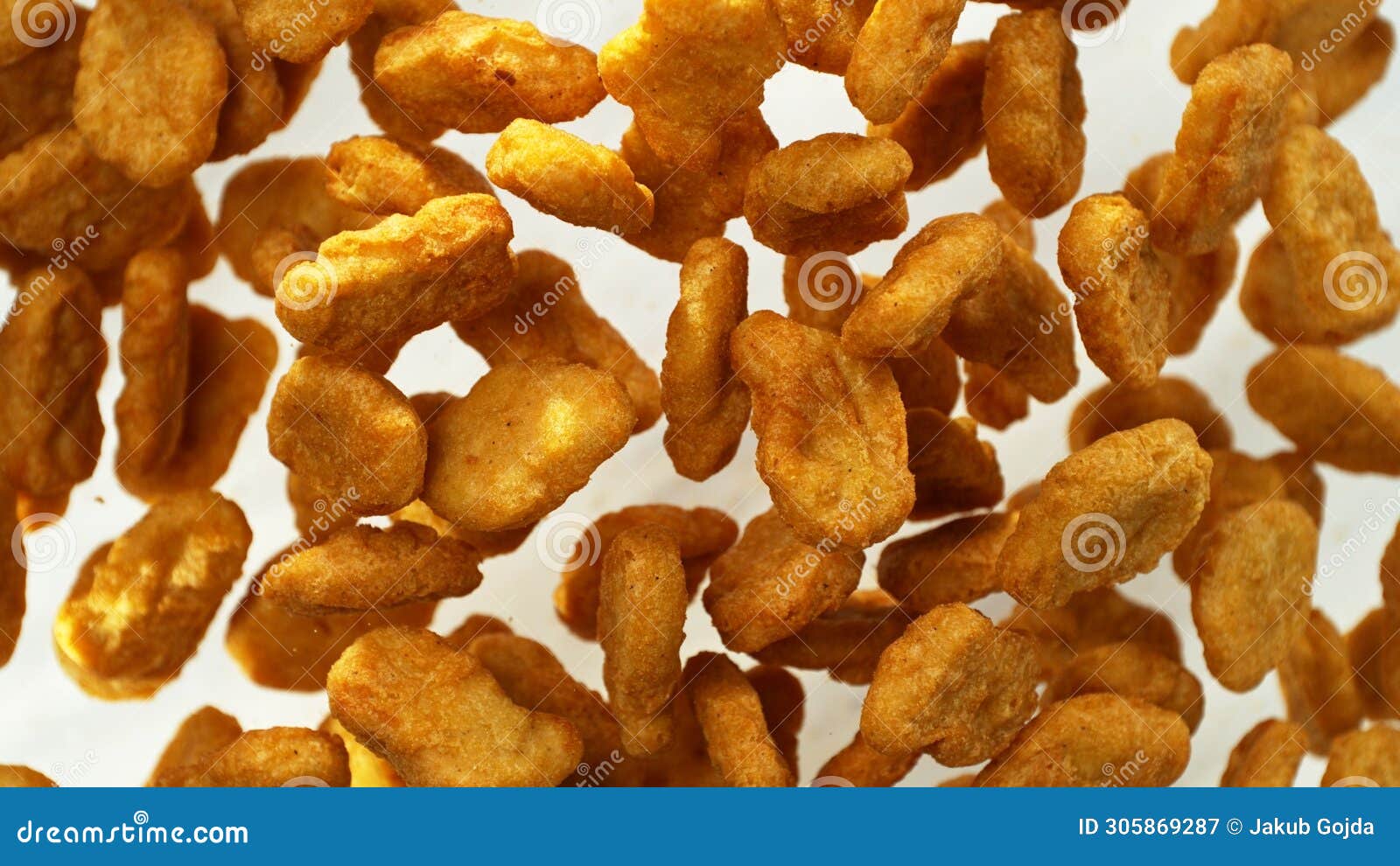 Falling Nuggets Isolated on Golden Background, Selective Focus. Stock ...