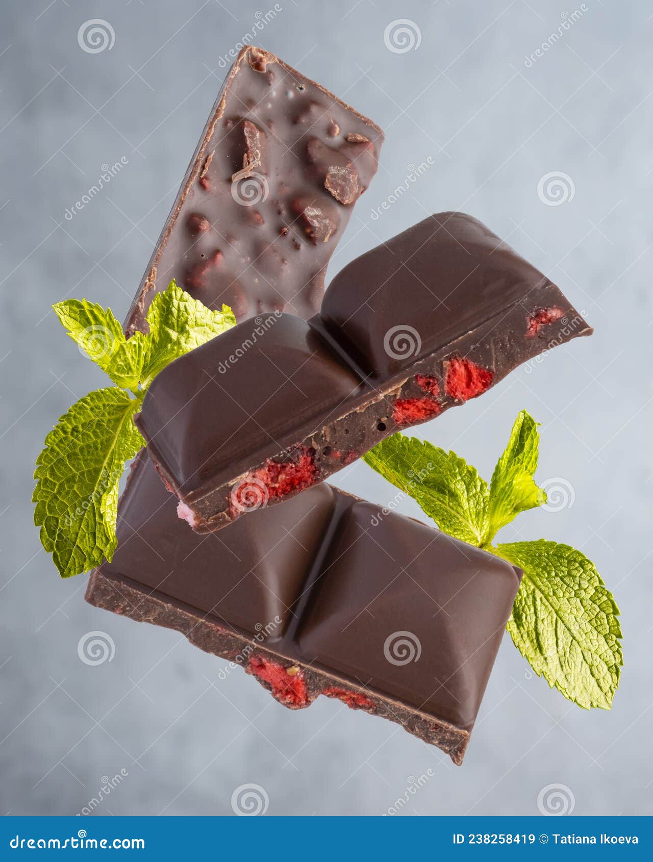 Falling Pieces of Chocolate and Mint Leaves on a Light Background ...