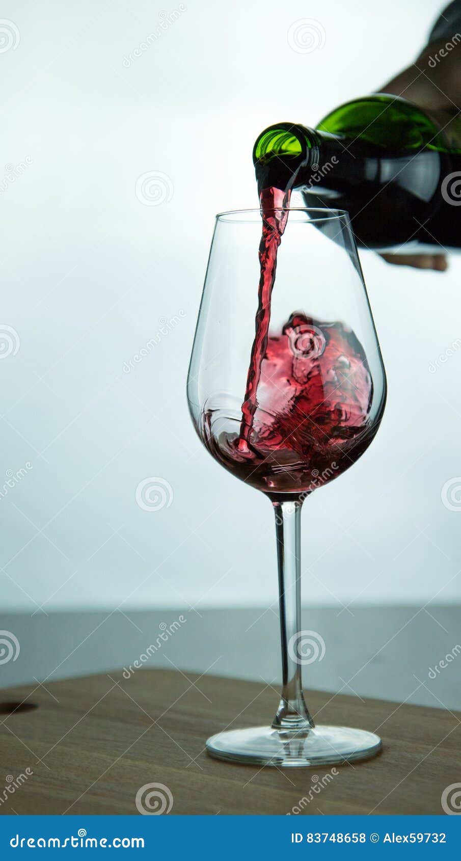 Falling red wine in glass stock photo. Image of bottle - 83748658