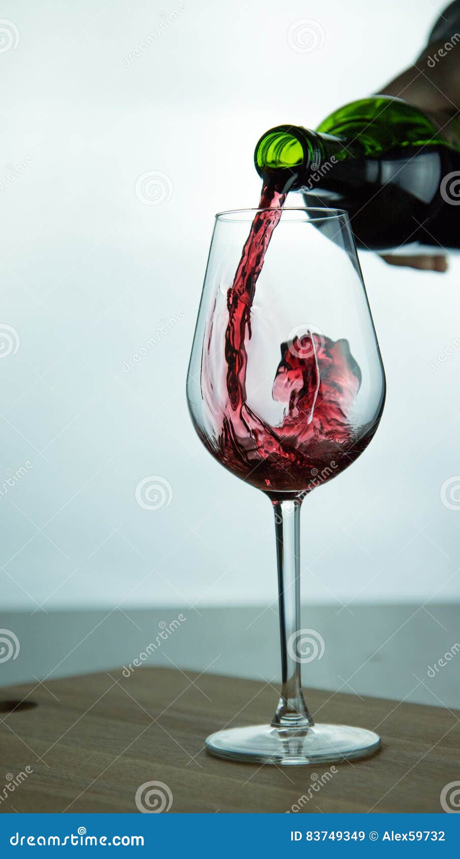 Falling red wine in glass stock image. Image of cheers - 83749349