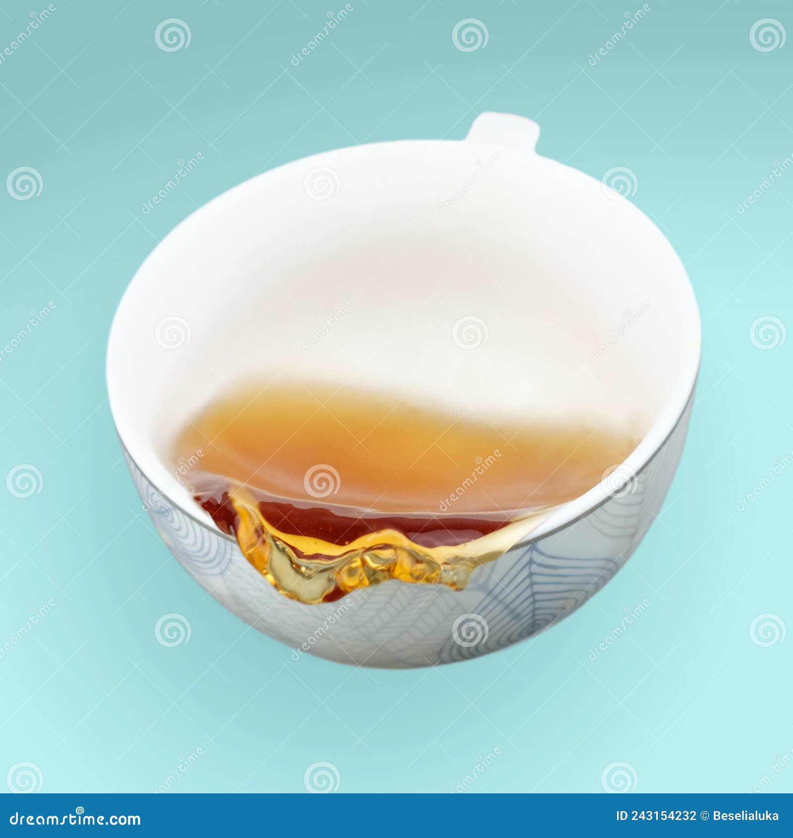 A falling teacup with tea stock photo. Image of beverage - 243154232
