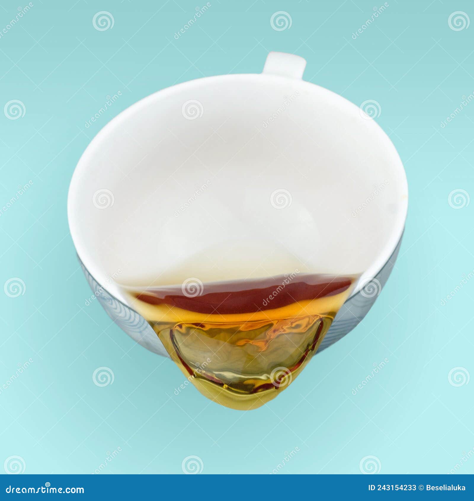 A falling teacup with tea stock image. Image of liquid - 243154233