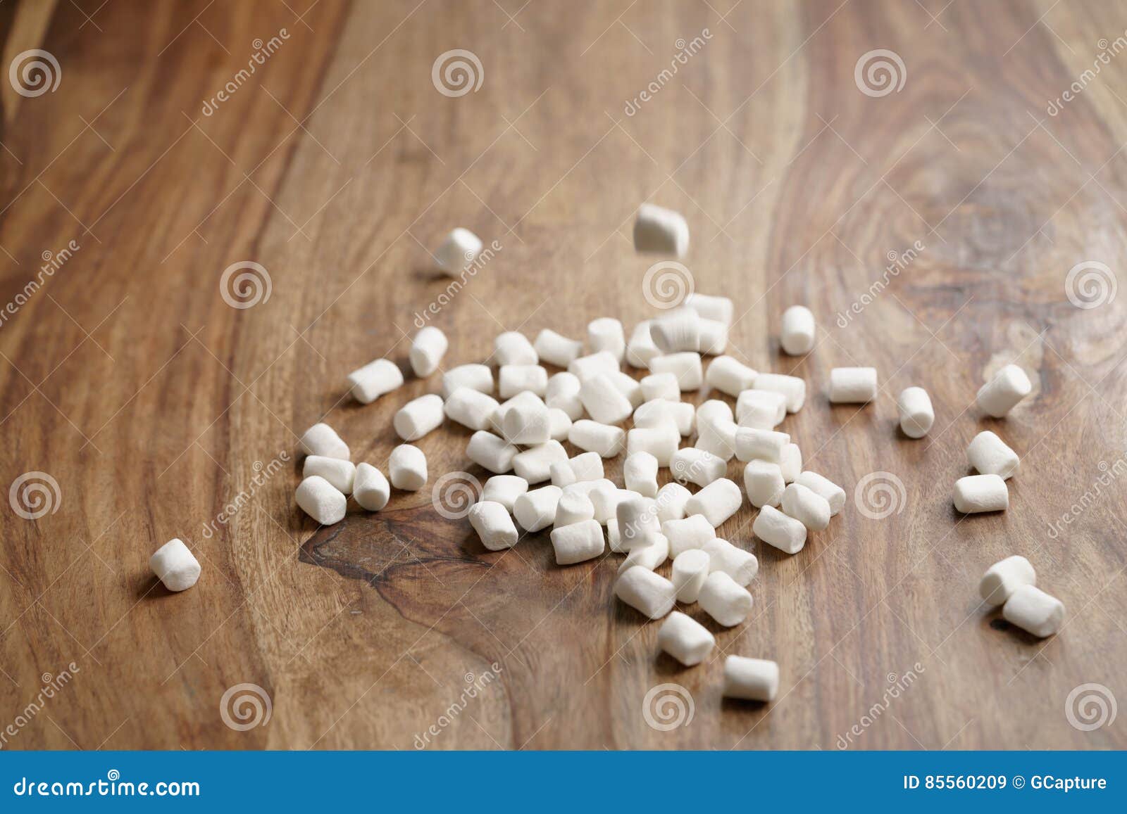 Falling White Marshmallows on Wooden Table Stock Image - Image of ...
