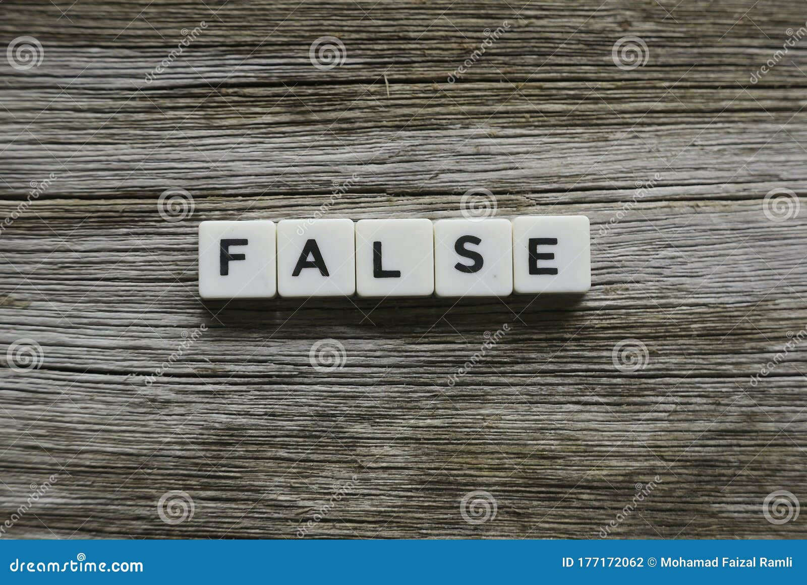 False Word Made Of Square Letter Word On Wooden Background Stock Photo ...