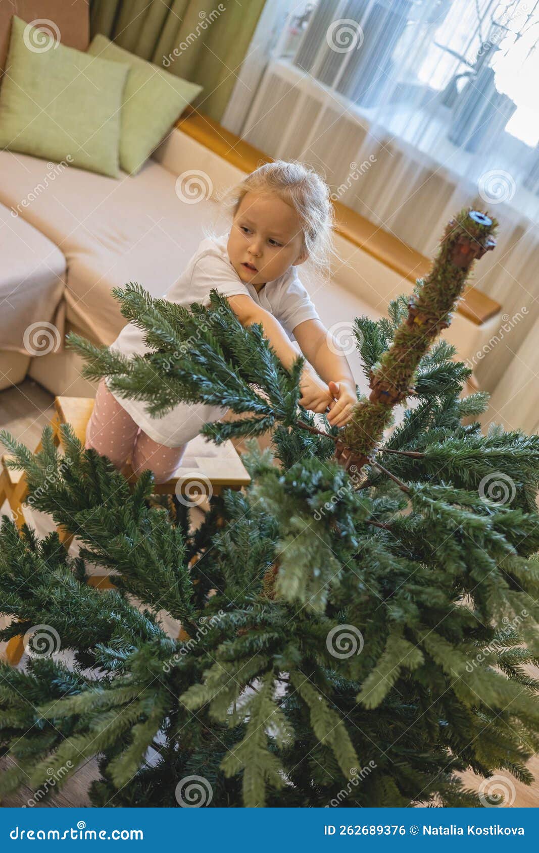 Family Assembling, Shaping Hook-in Artificial Christmas Tree at Home ...